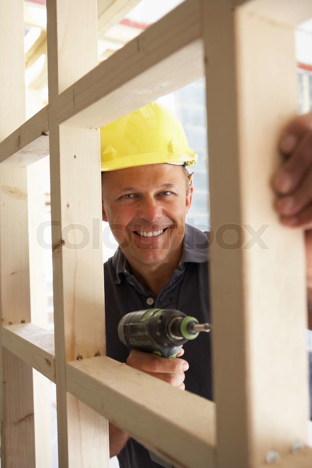 Construction Worker Building Timber Frame In New Home | Stock image ...