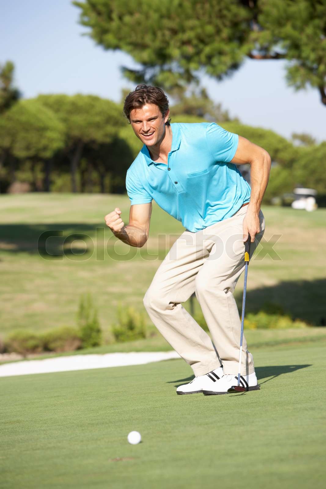 Male Golfer On Golf Course Putting On Green | Stock image | Colourbox