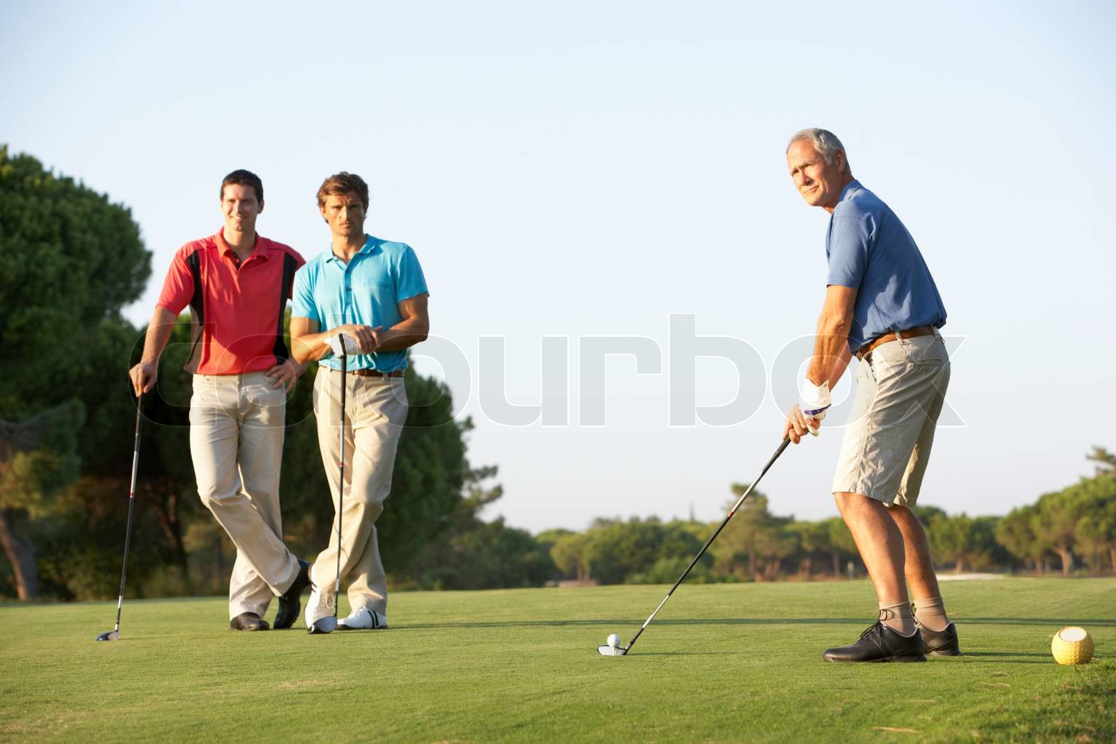 Group Of Male Golfers Teeing Off On Golf Course | Stock image | Colourbox