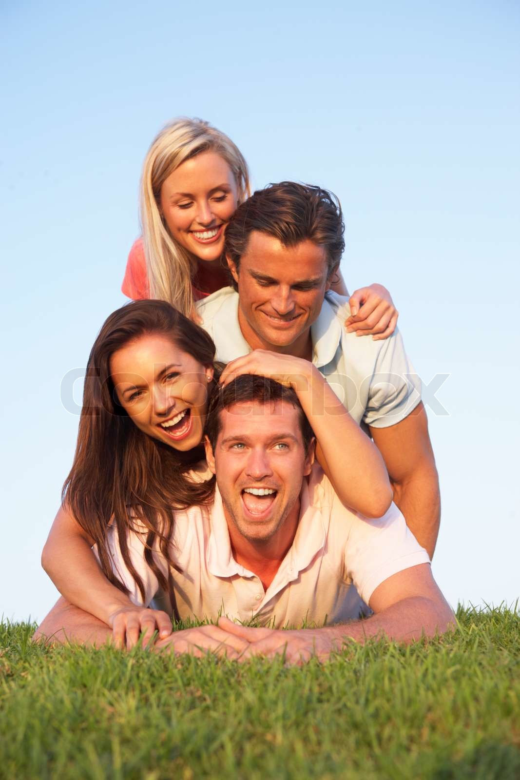 Two, young couples posing on a field | Stock image | Colourbox