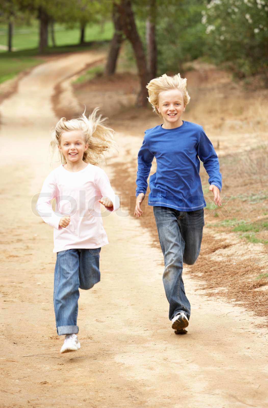 Two Children running in park | Stock image | Colourbox