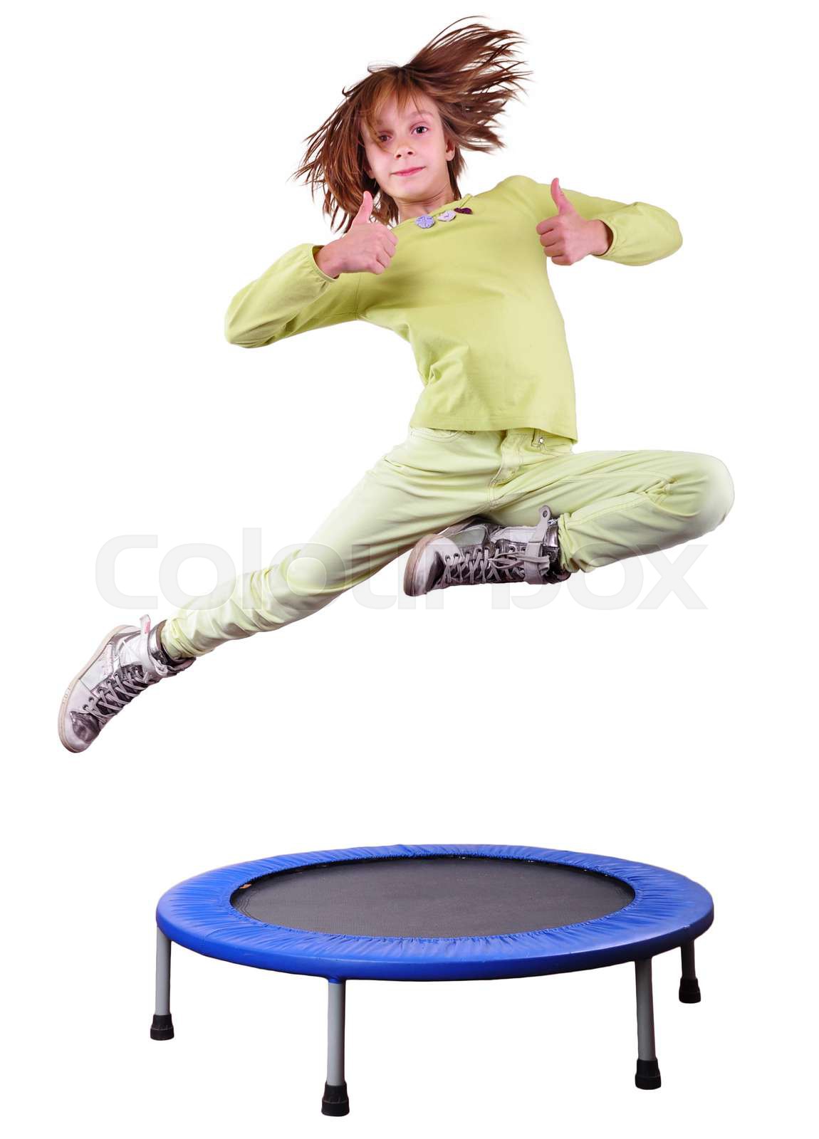cute girl exercising and jumping on a trampoline | Stock image | Colourbox