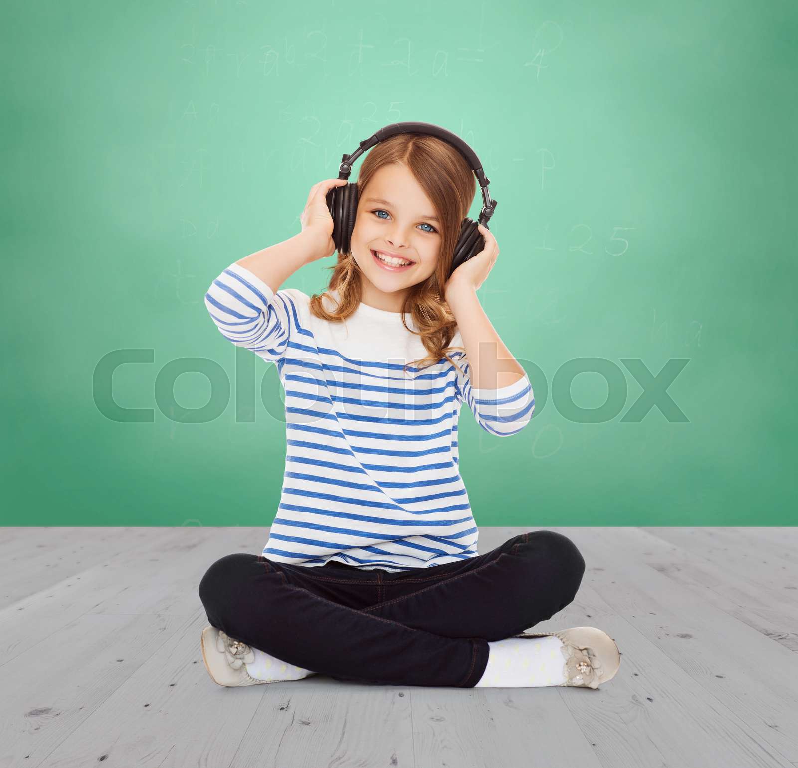 happy girl with headphones listening to music | Stock image | Colourbox