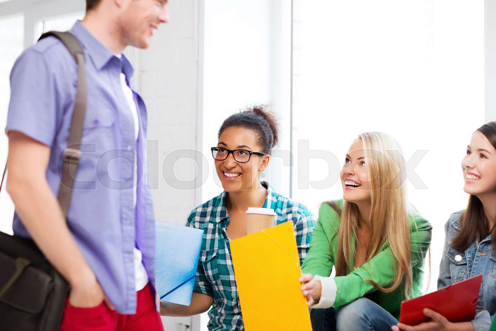 students communicating and laughing at school | Stock image | Colourbox