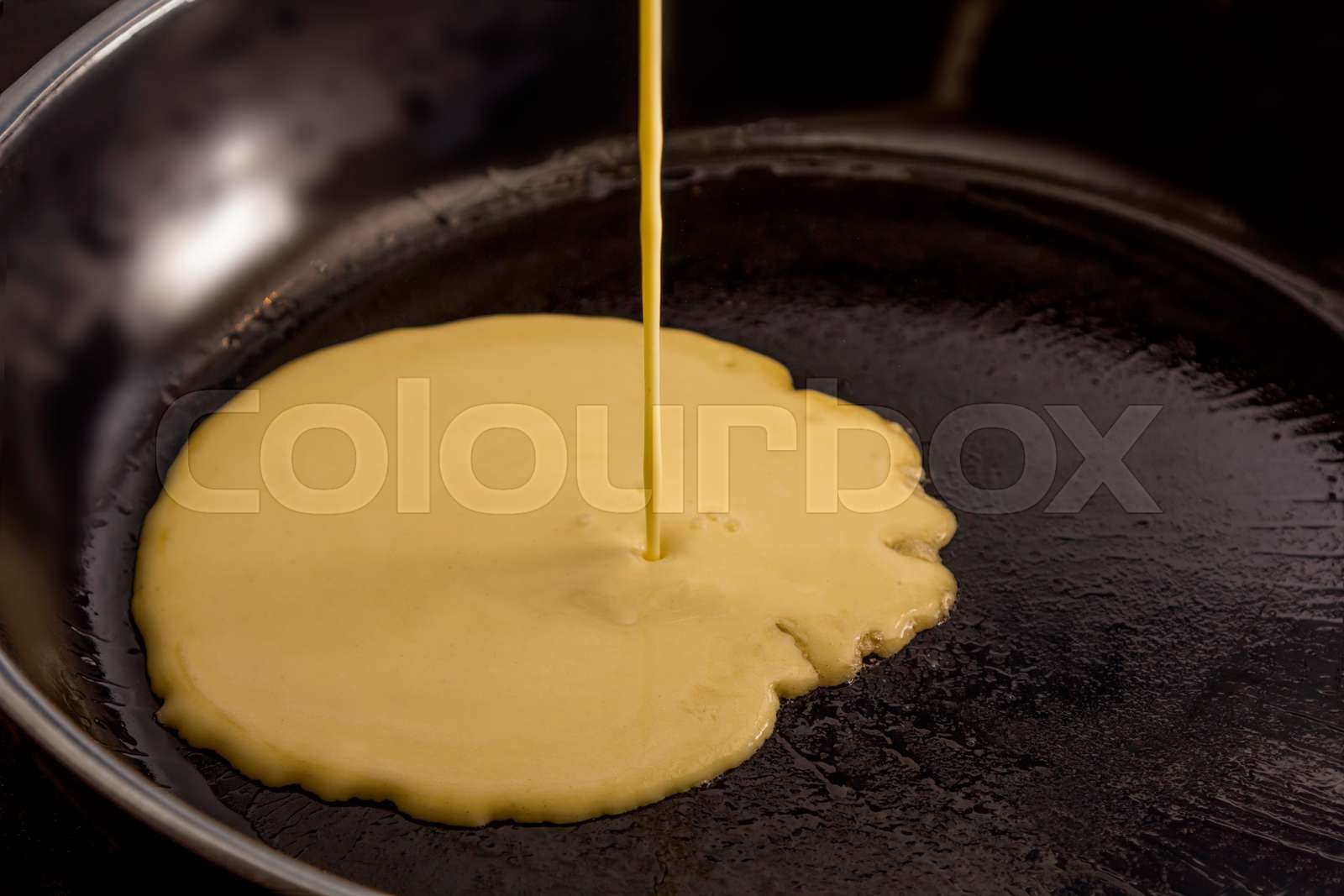 Pancake batters pouring in pan | Stock image | Colourbox