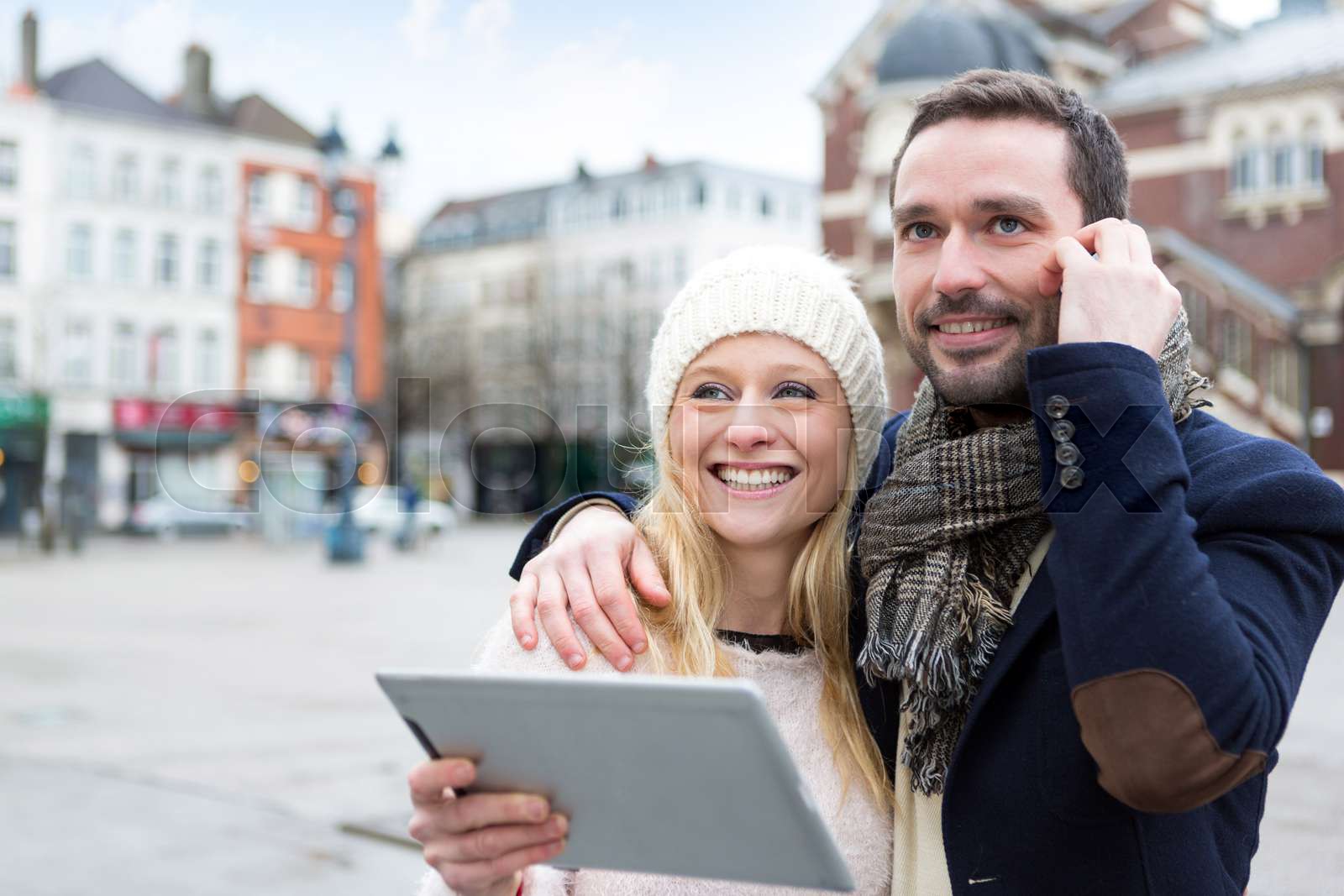 People on holidays visiting city helped by tablet | Stock image | Colourbox