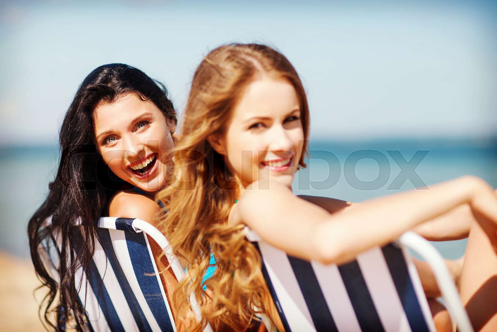 girls sunbathing on the beach chairs | Stock image | Colourbox