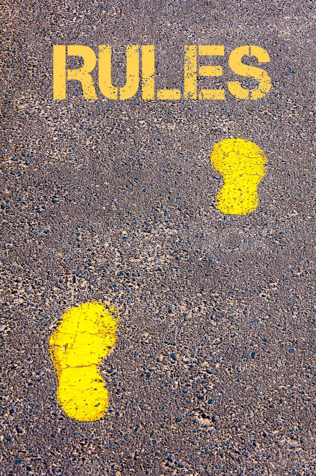 Yellow footsteps on sidewalk towards Rules message | Stock image ...
