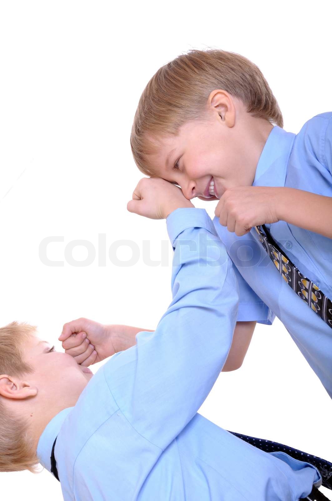 Two schoolboys fighting. Isolated over white. | Stock image | Colourbox