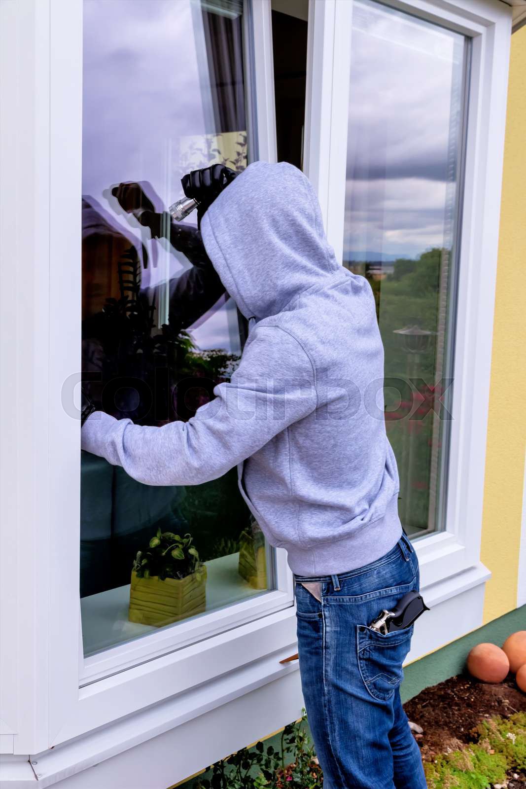 burglar at a window | Stock image | Colourbox