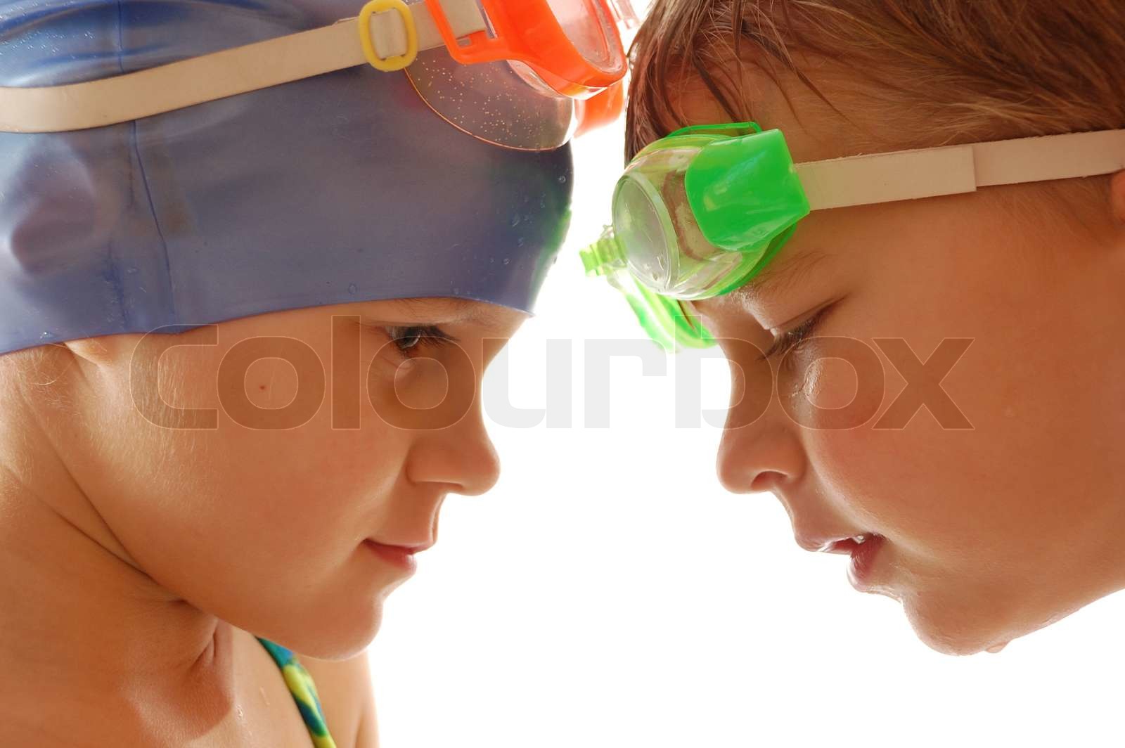 two concentrated kids with goggles on their heads | Stock image | Colourbox
