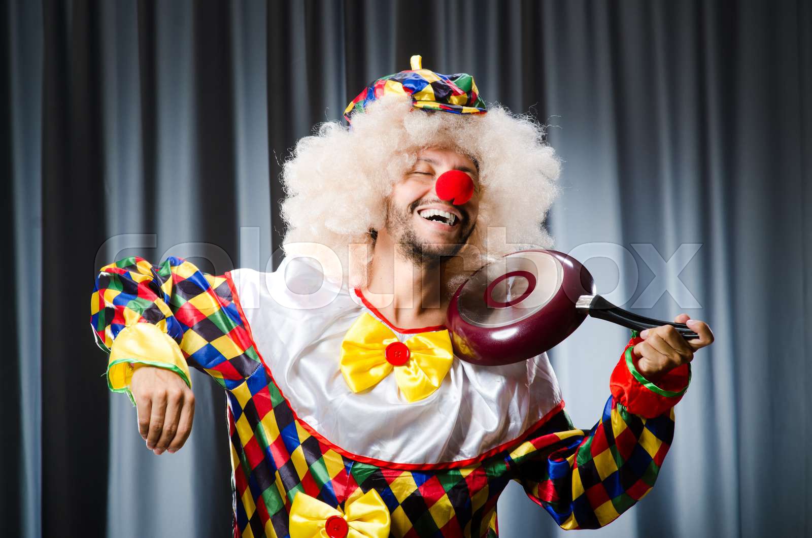 Angry clown with frying pan | Stock image | Colourbox