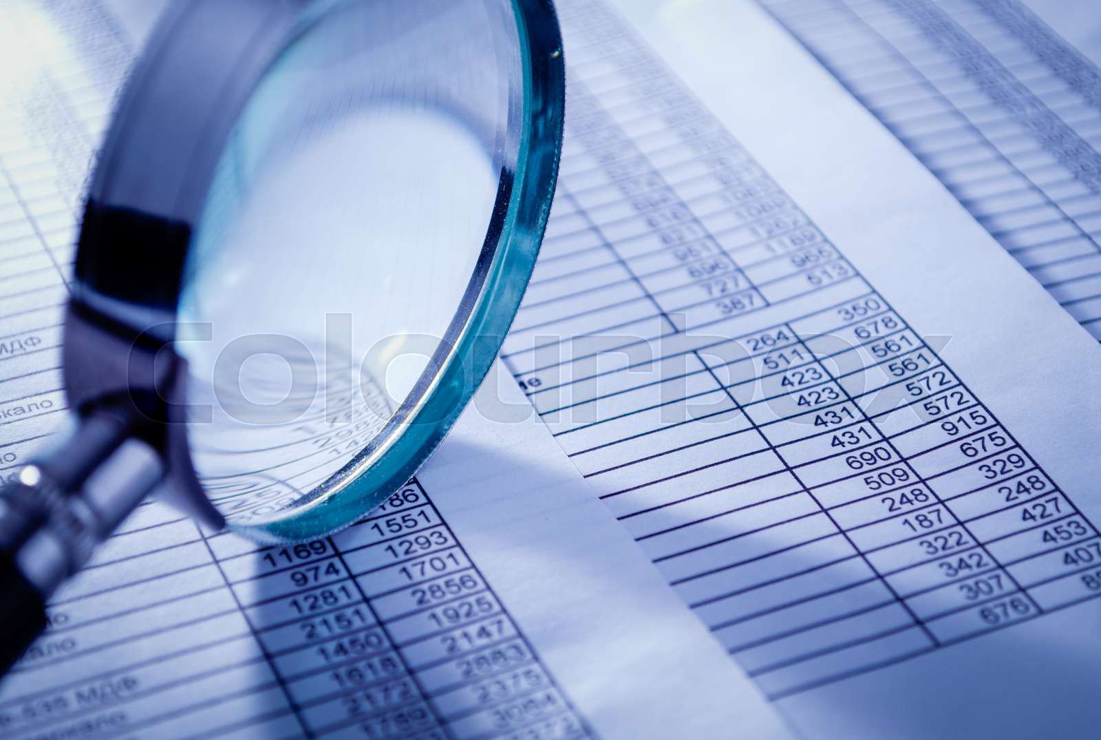 Conceptual Magnifying Glass on Invoice Reports | Stock image | Colourbox