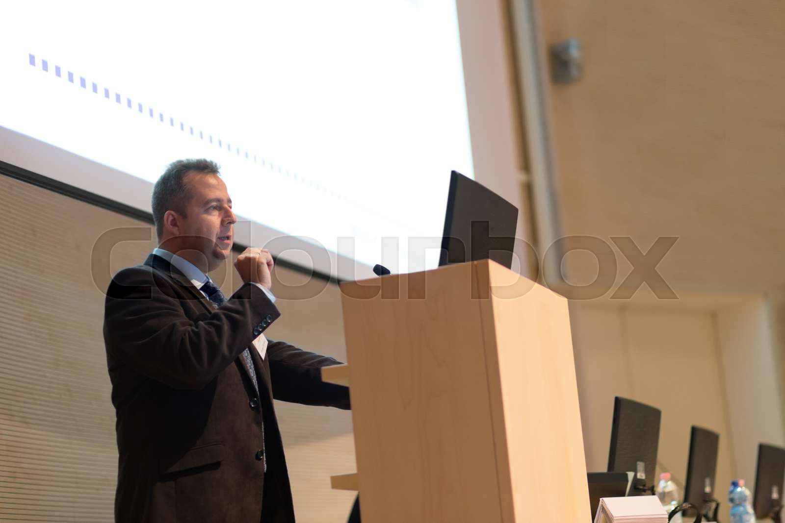 Speaker giving talk on podium at Business Conference. | Stock image ...