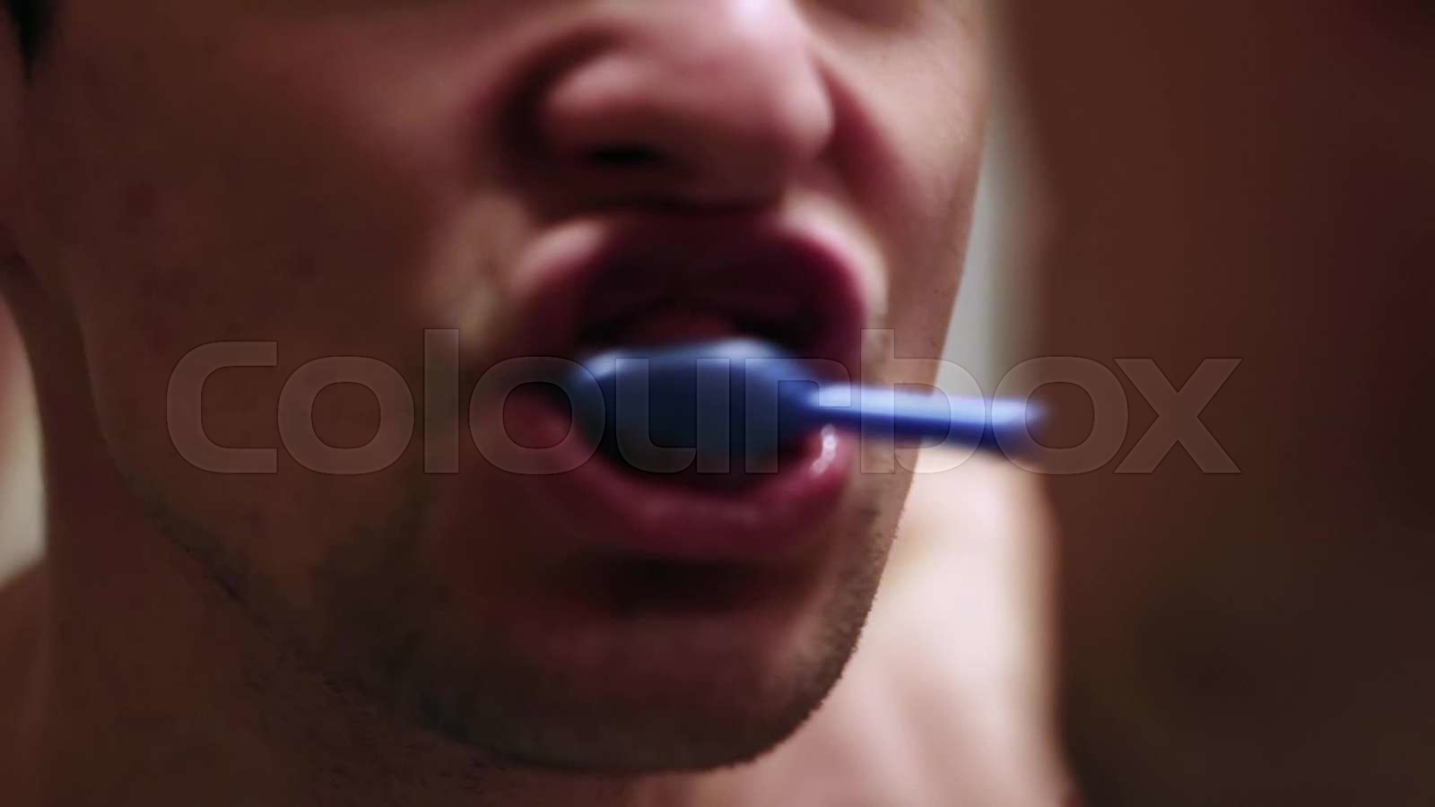 Man brushing his teeth with a toothbrush | Stock video | Colourbox
