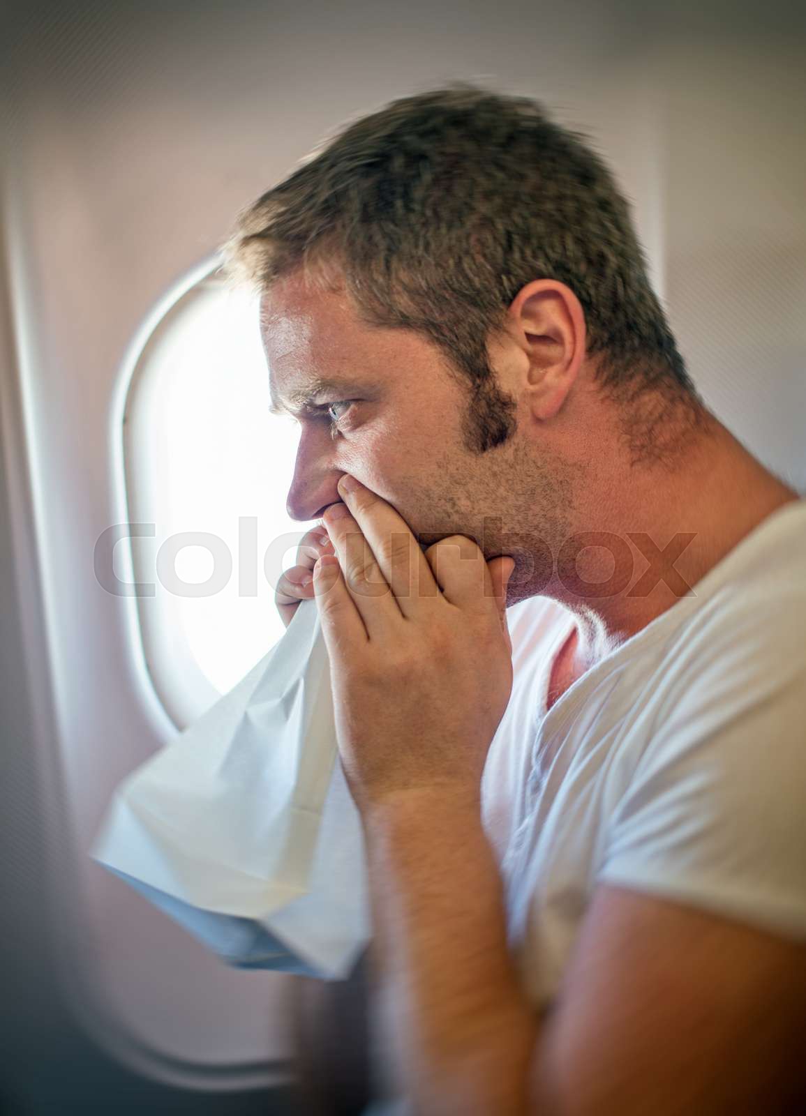 Airsickness. Man feels very bad on the plane. | Stock image | Colourbox