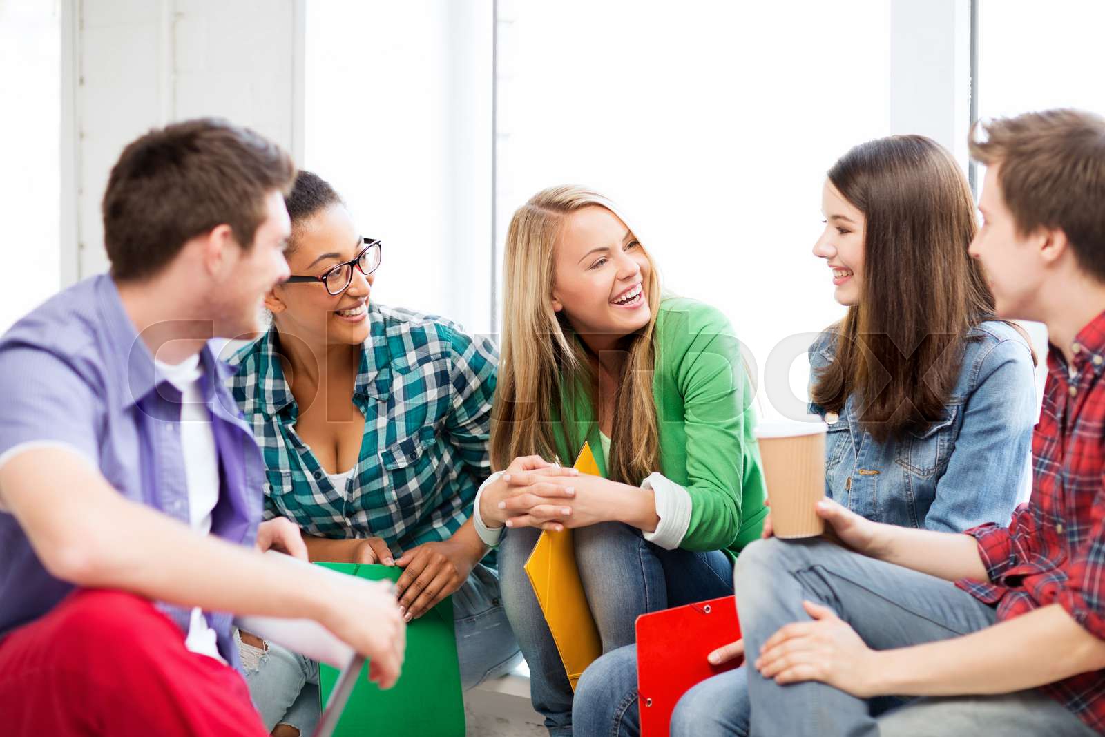 students communicating and laughing at school | Stock image | Colourbox