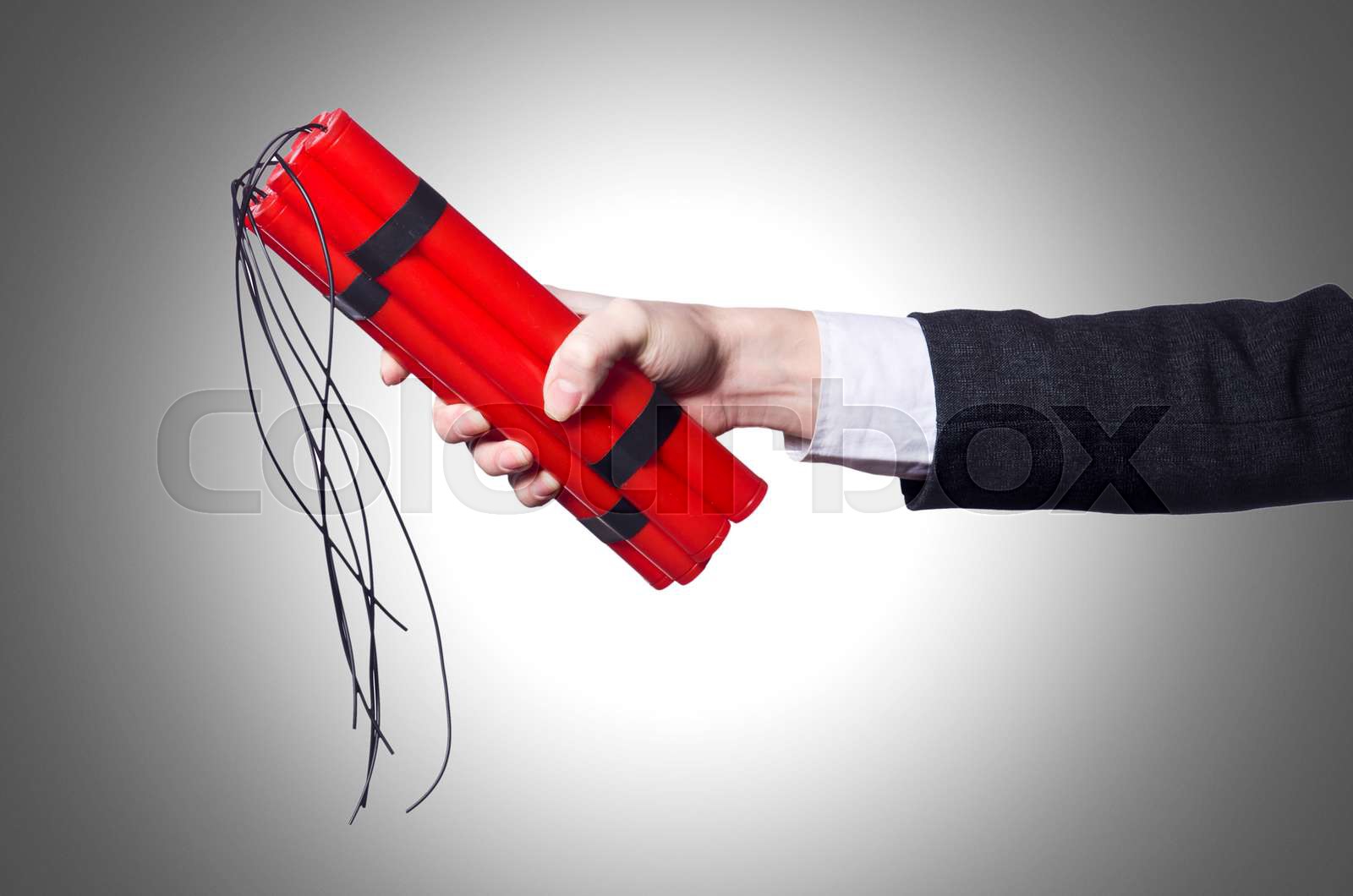 Hand holding bars of dynamite on white | Stock image | Colourbox