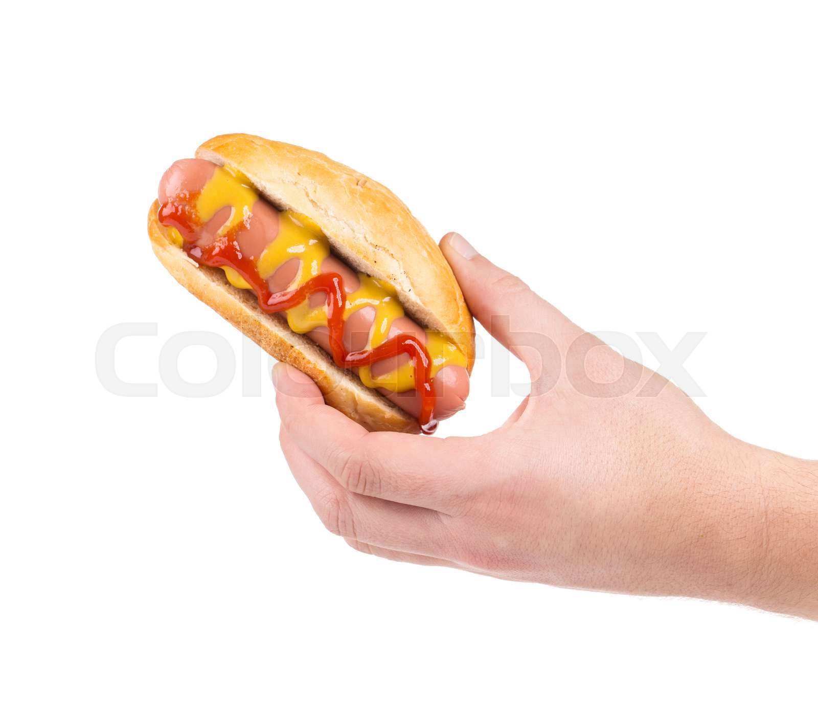 Hand holding hot dog. | Stock image | Colourbox