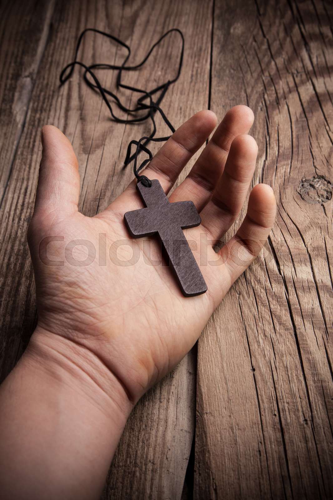 Cross in hand | Stock image | Colourbox