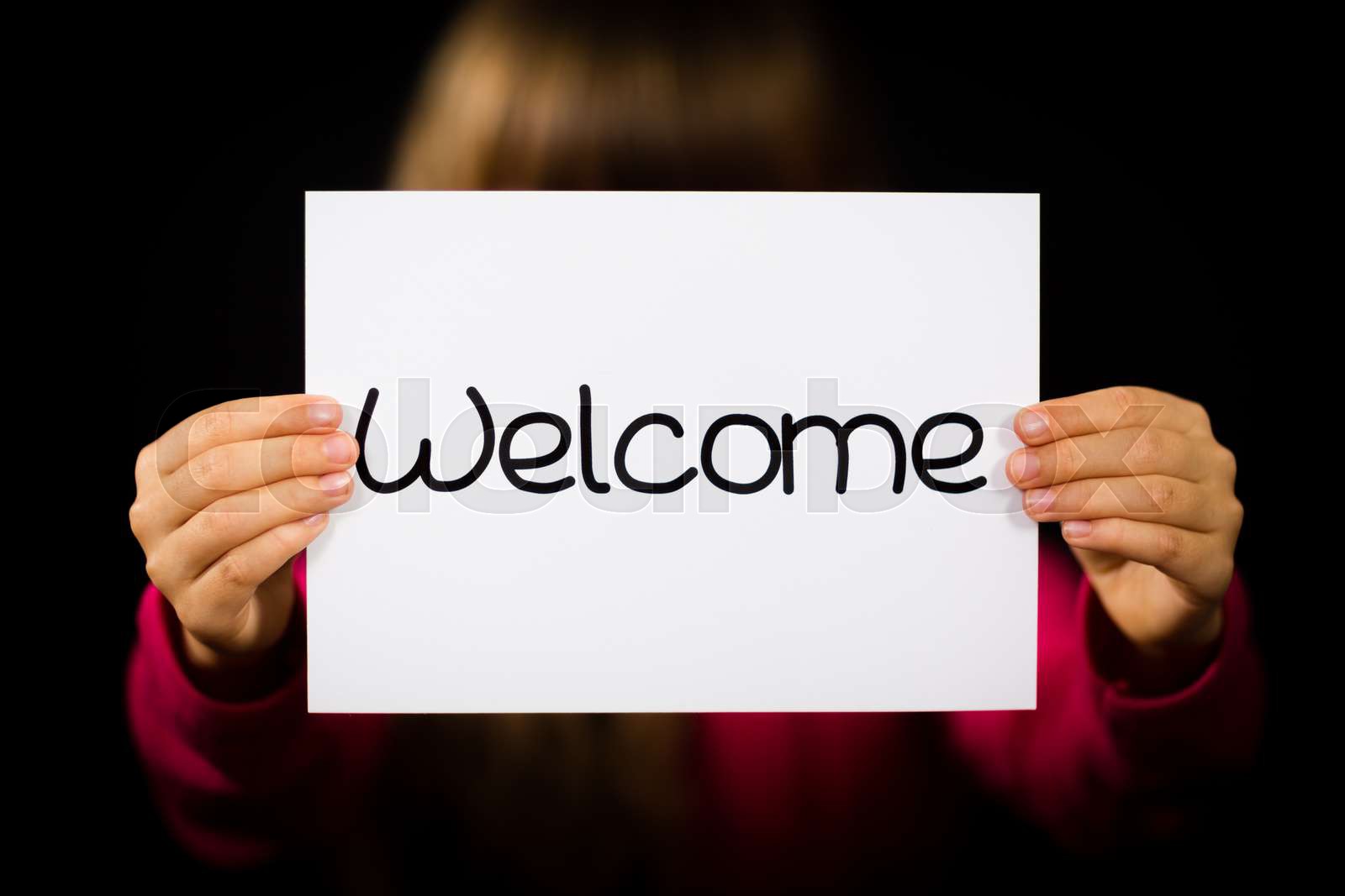 Child holding Welcome sign | Stock image | Colourbox