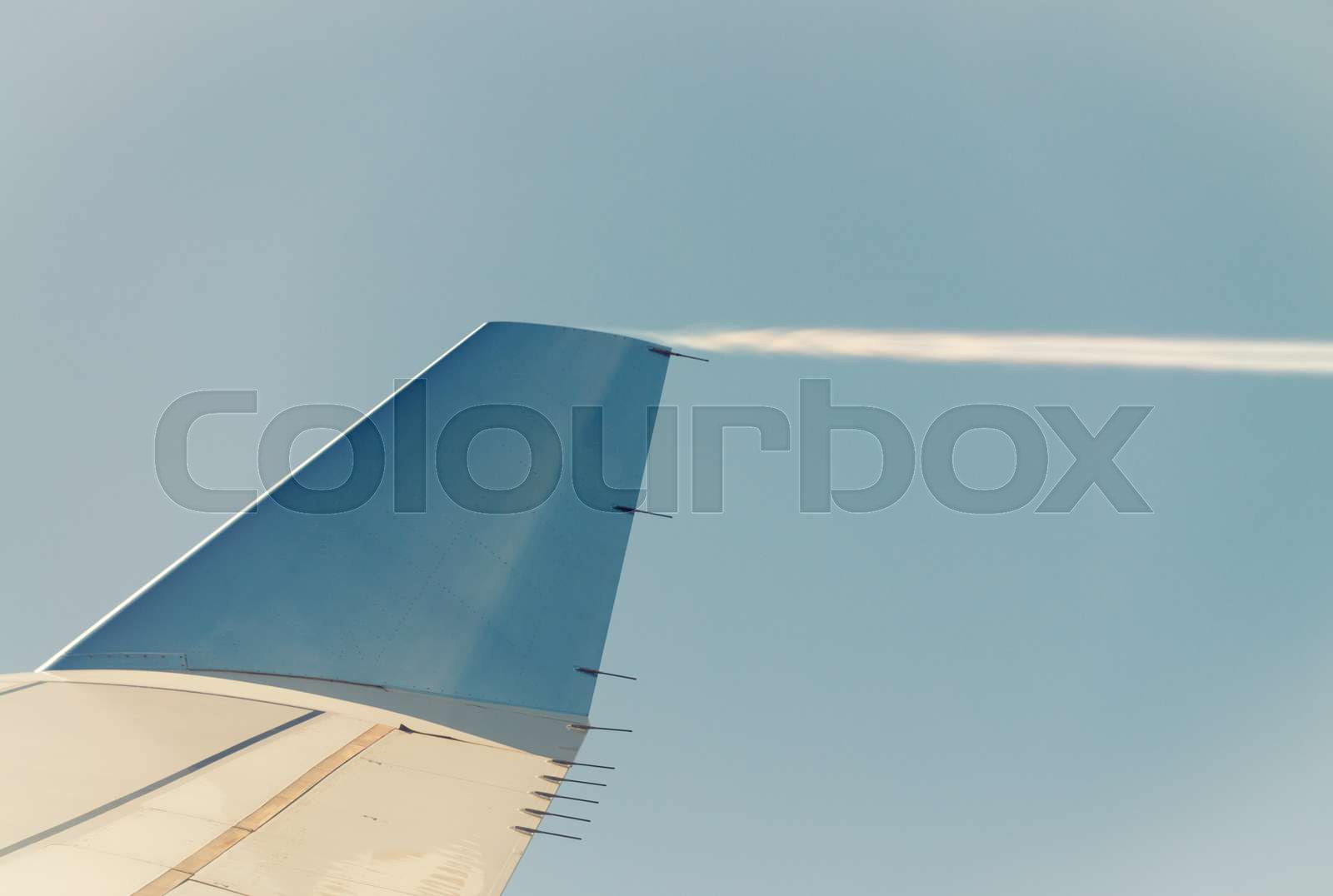 Air trail form airplane wing | Stock image | Colourbox