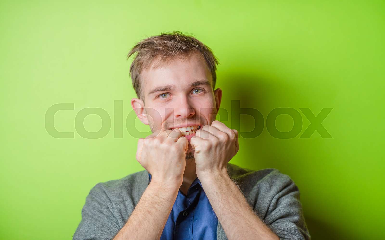 Closeup portrait of a man resting chin on hand, brows raised and ...