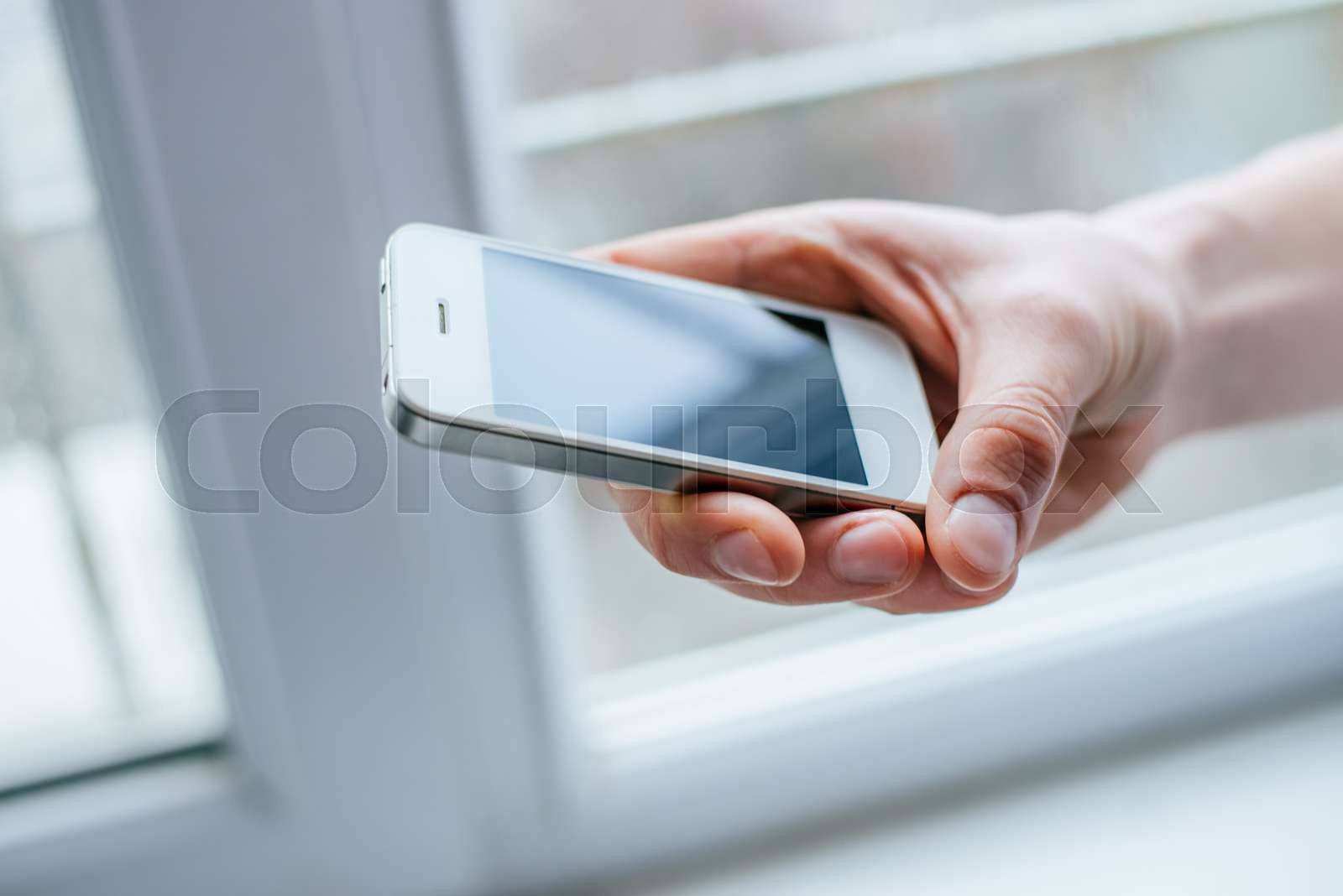 Mobile phone With hand | Stock image | Colourbox