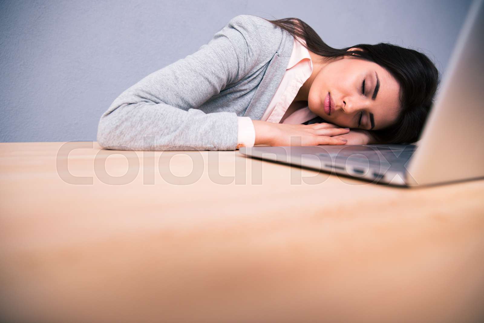 Young pretty woman sleeping on the table | Stock image | Colourbox