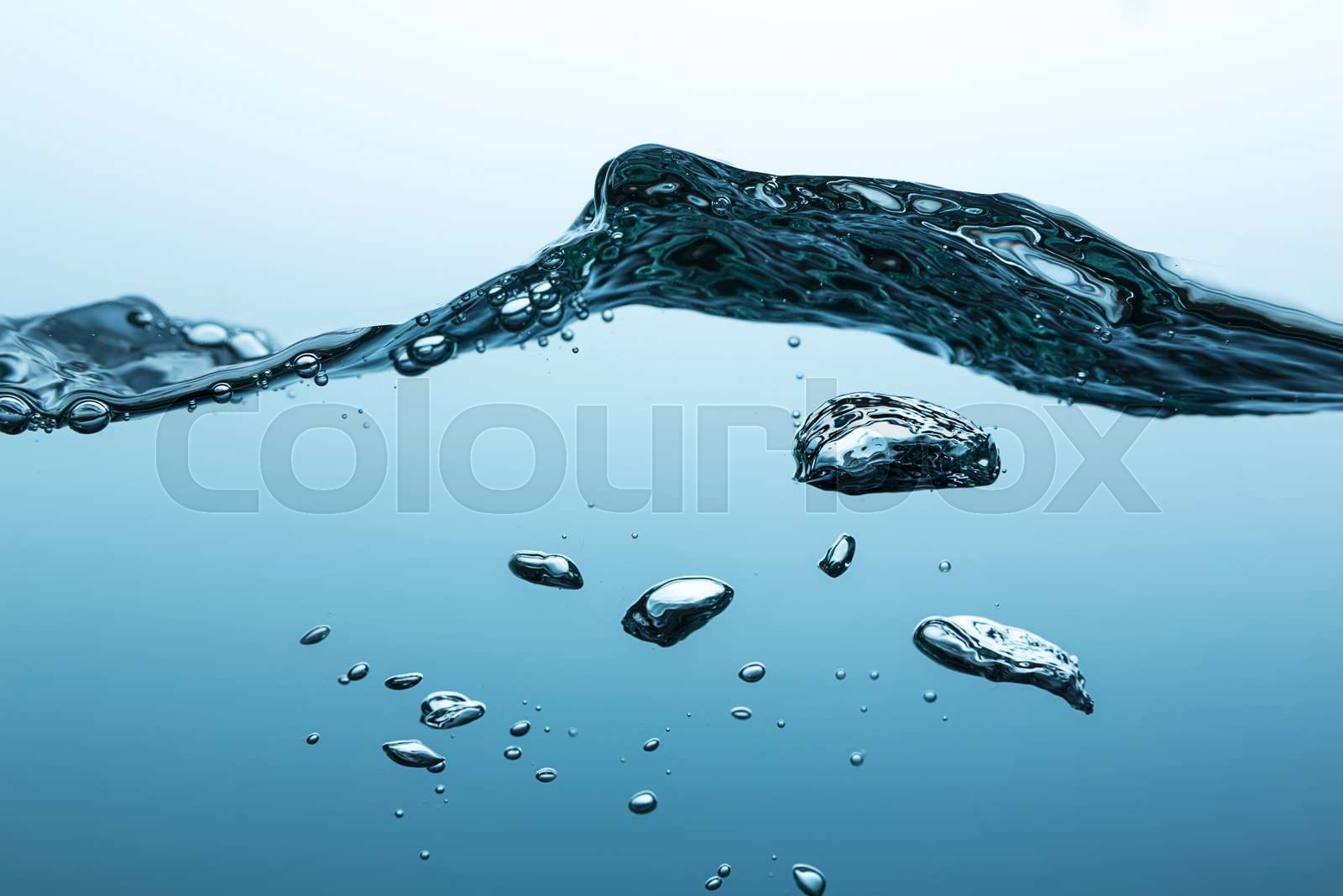 Bubbels in wavy water | Stock image | Colourbox