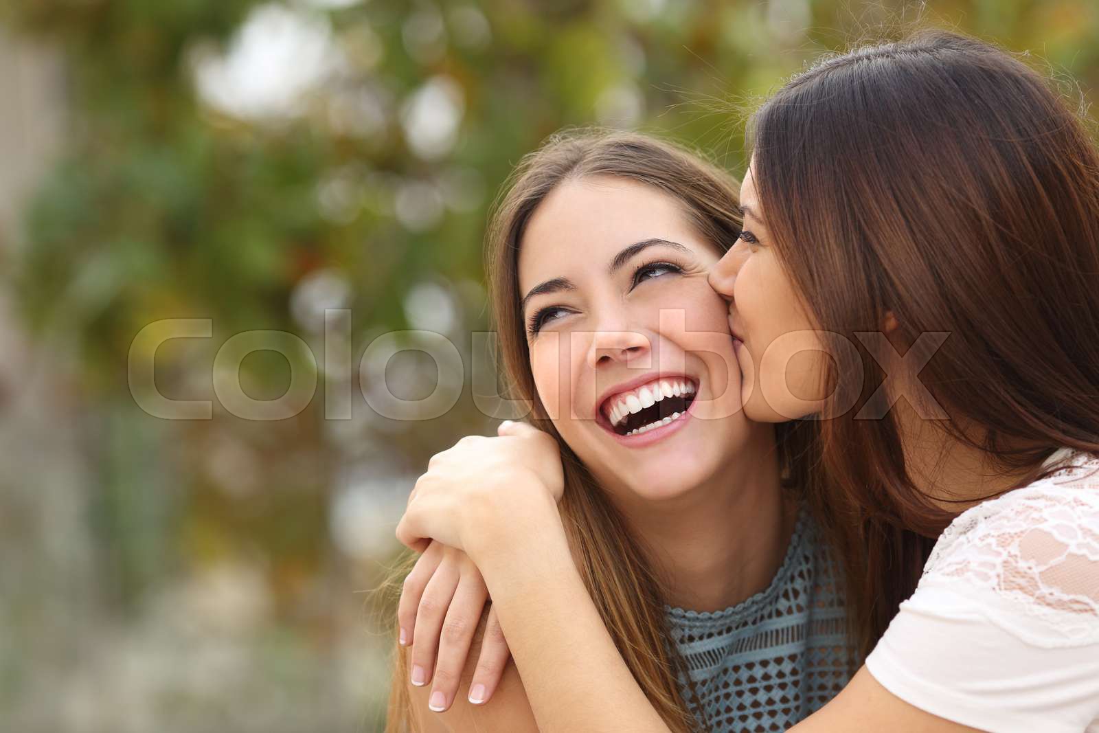 Two funny women friends laughing and kissing | Stock image | Colourbox
