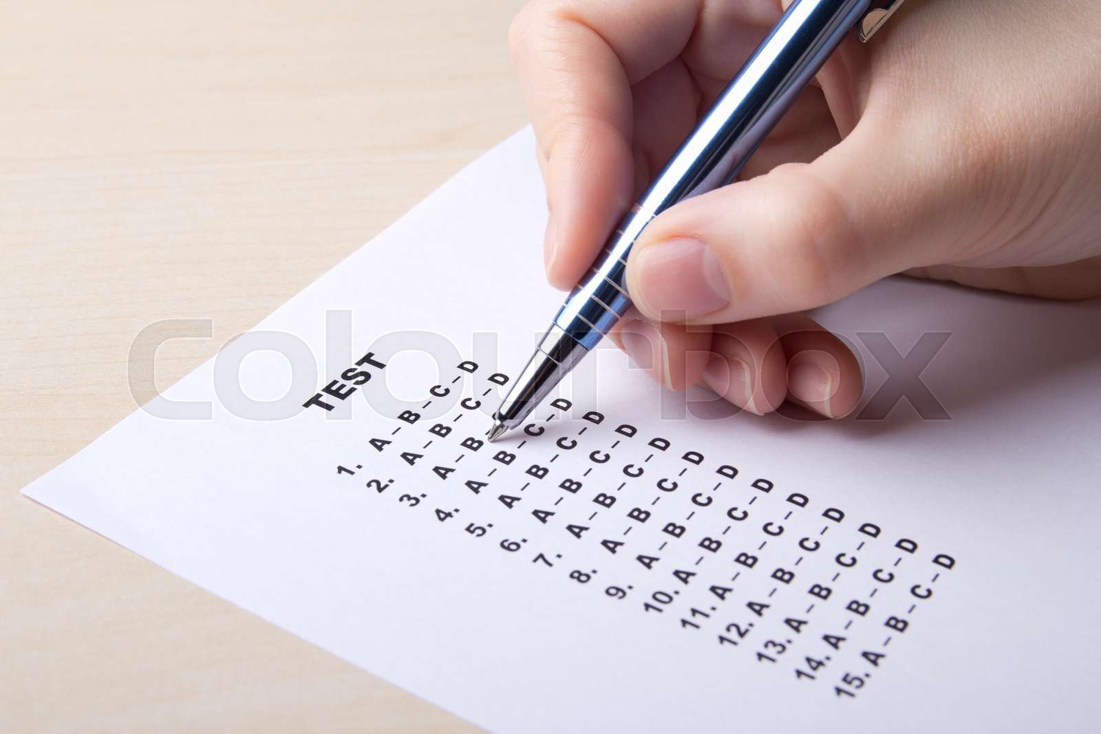 woman filling test sheet with answers | Stock image | Colourbox