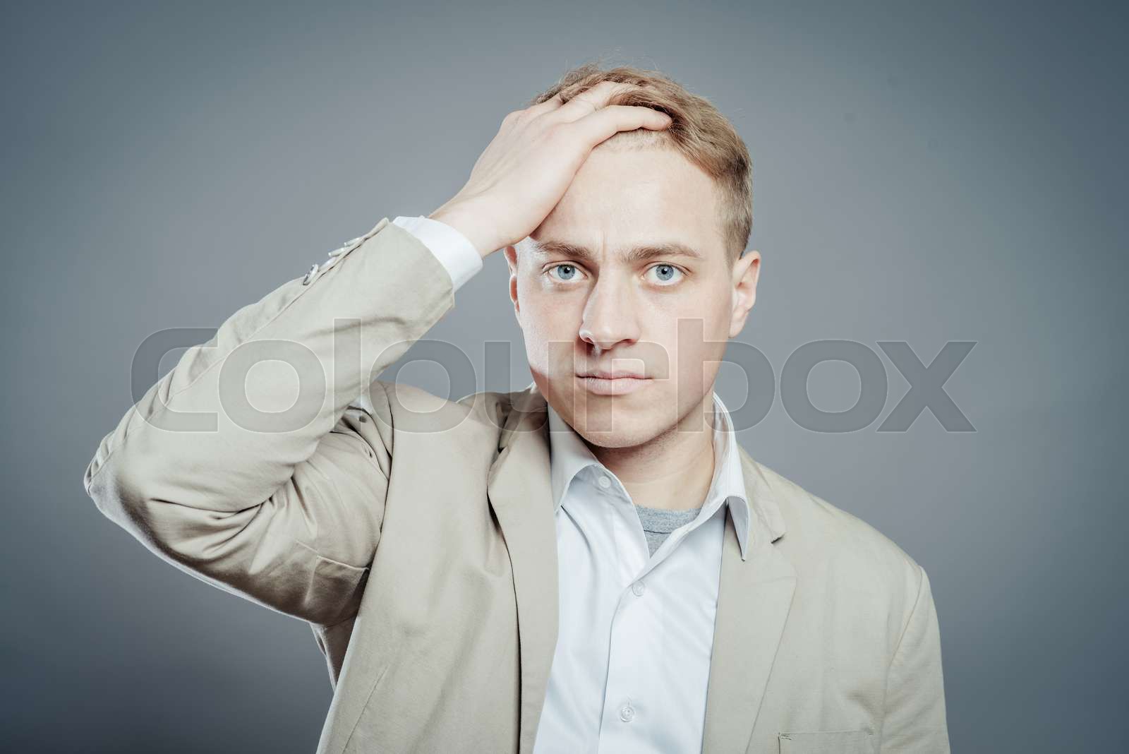 Closeup portrait of angry, frustrated man, hand on head. Negative human ...