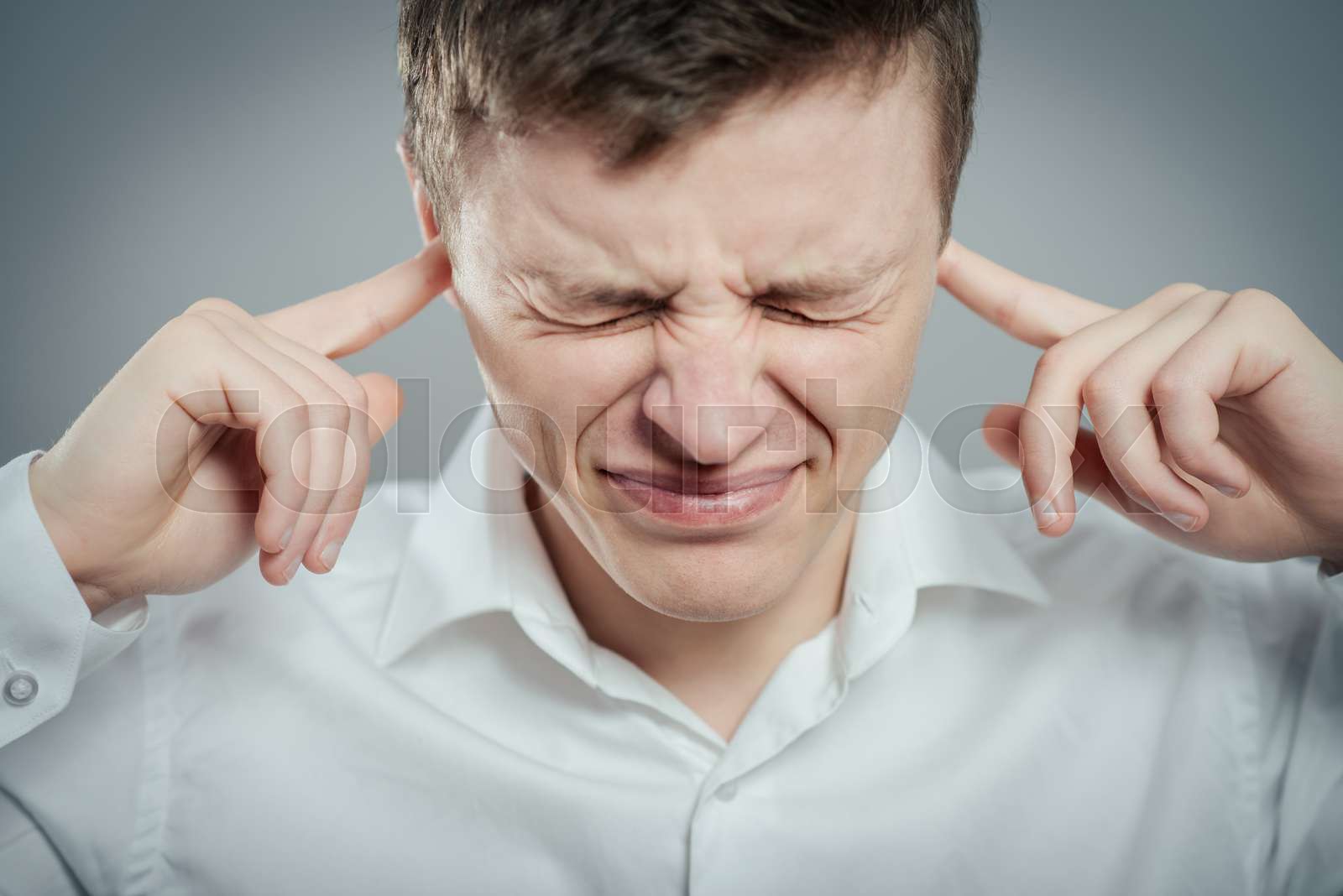 Man covering his hears | Stock image | Colourbox