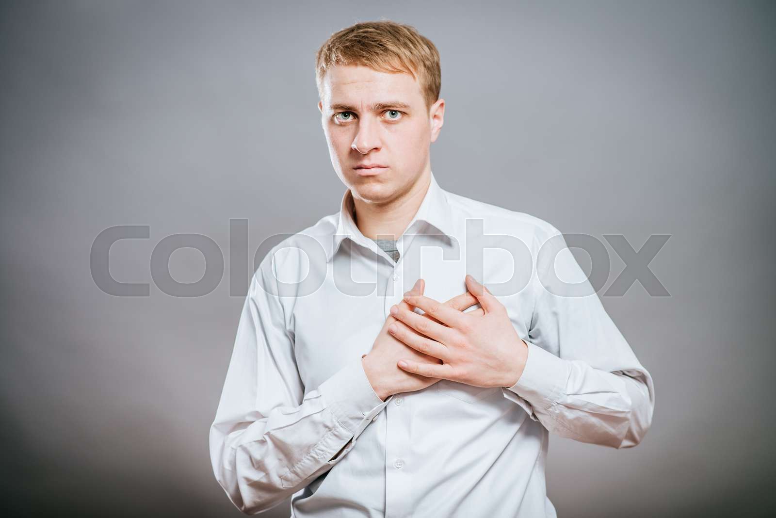 Handsome male resting hand on his chest | Stock image | Colourbox