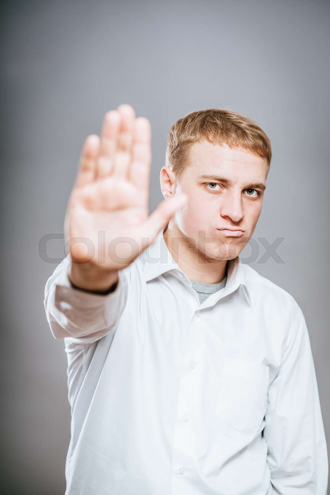 angry attractive young man showing stop hand | Stock image | Colourbox