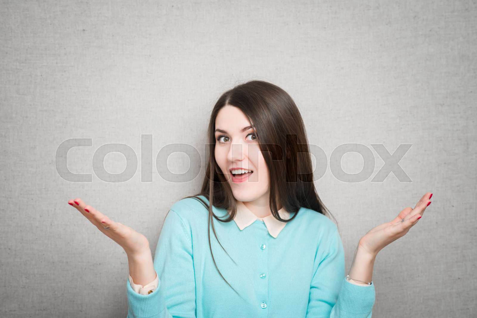 Portrait young woman arms out shrugs shoulders asking who cares so what ...