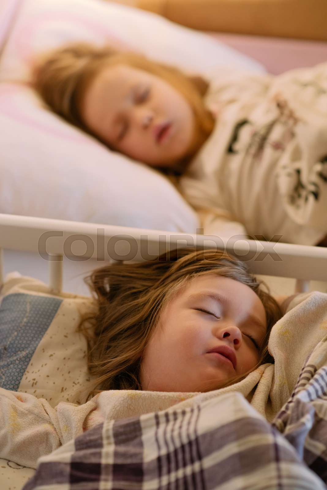 children sleeping girl in pajamas on the bed | Stock image | Colourbox