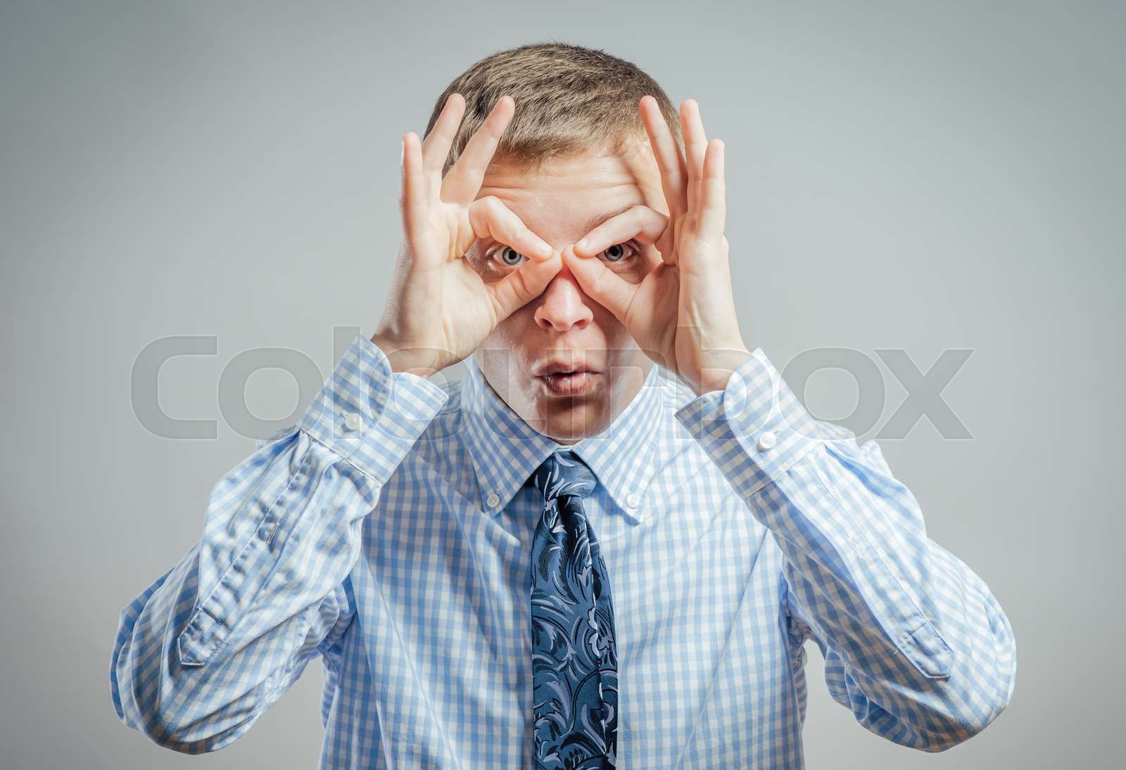 Funny man with hand over eyes, looking through fingers | Stock image ...