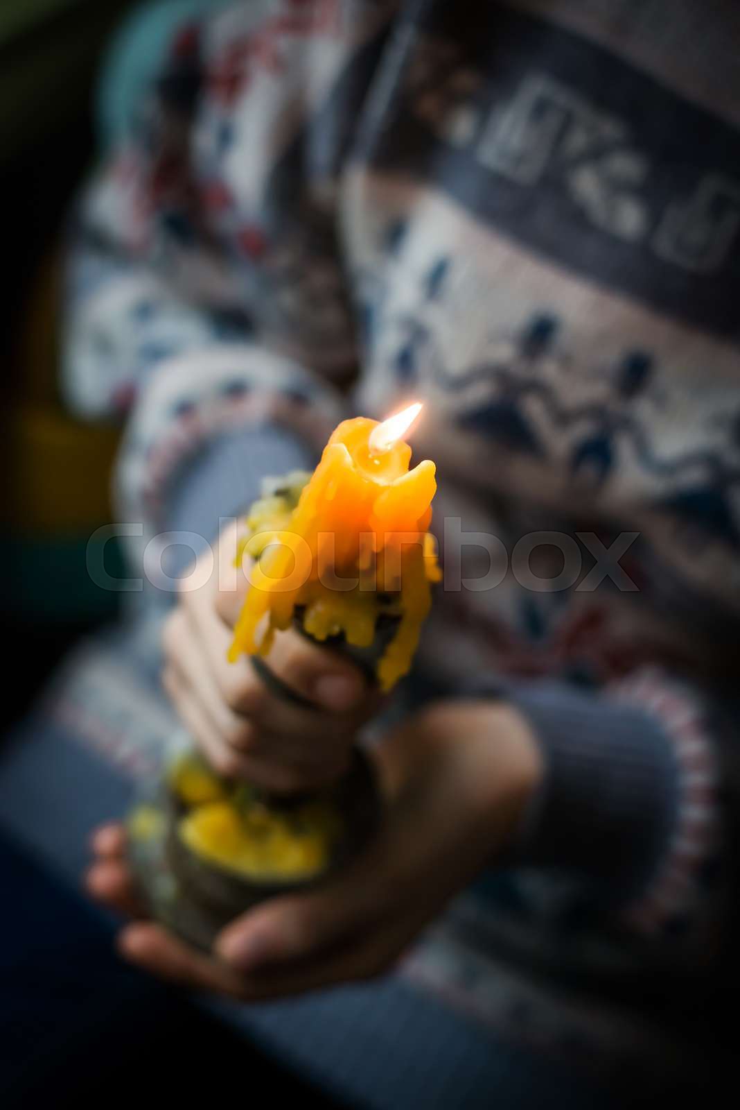 hands hold a candlestick with a candle | Stock image | Colourbox