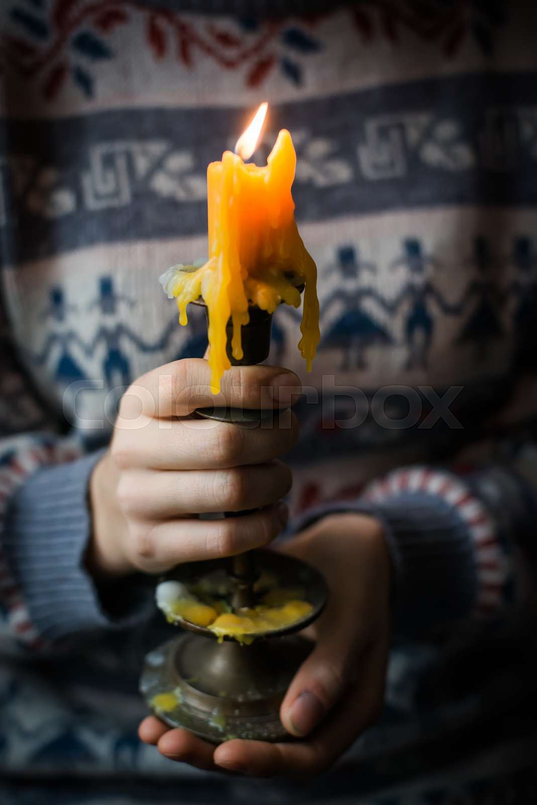 hands hold a candlestick with a candle | Stock image | Colourbox