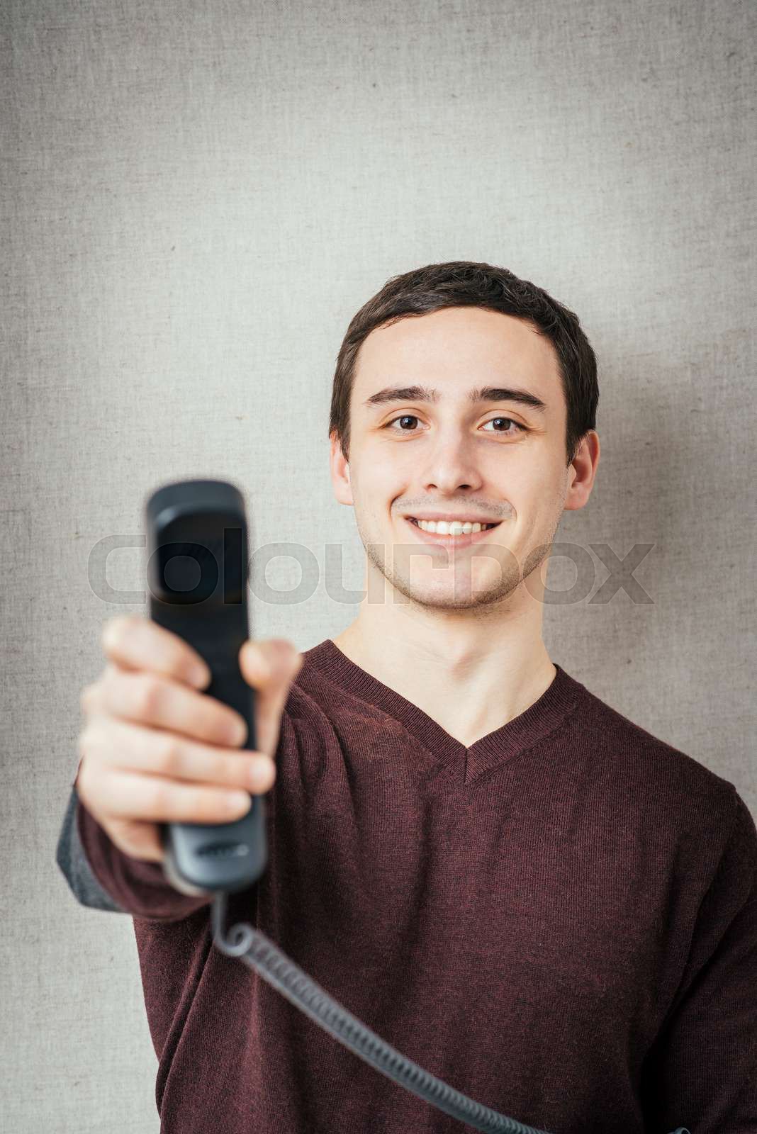 Man holding a landline telephone receiver | Stock image | Colourbox