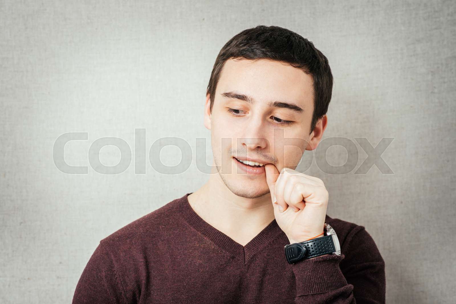 Worried man nibbling his fingernails | Stock image | Colourbox