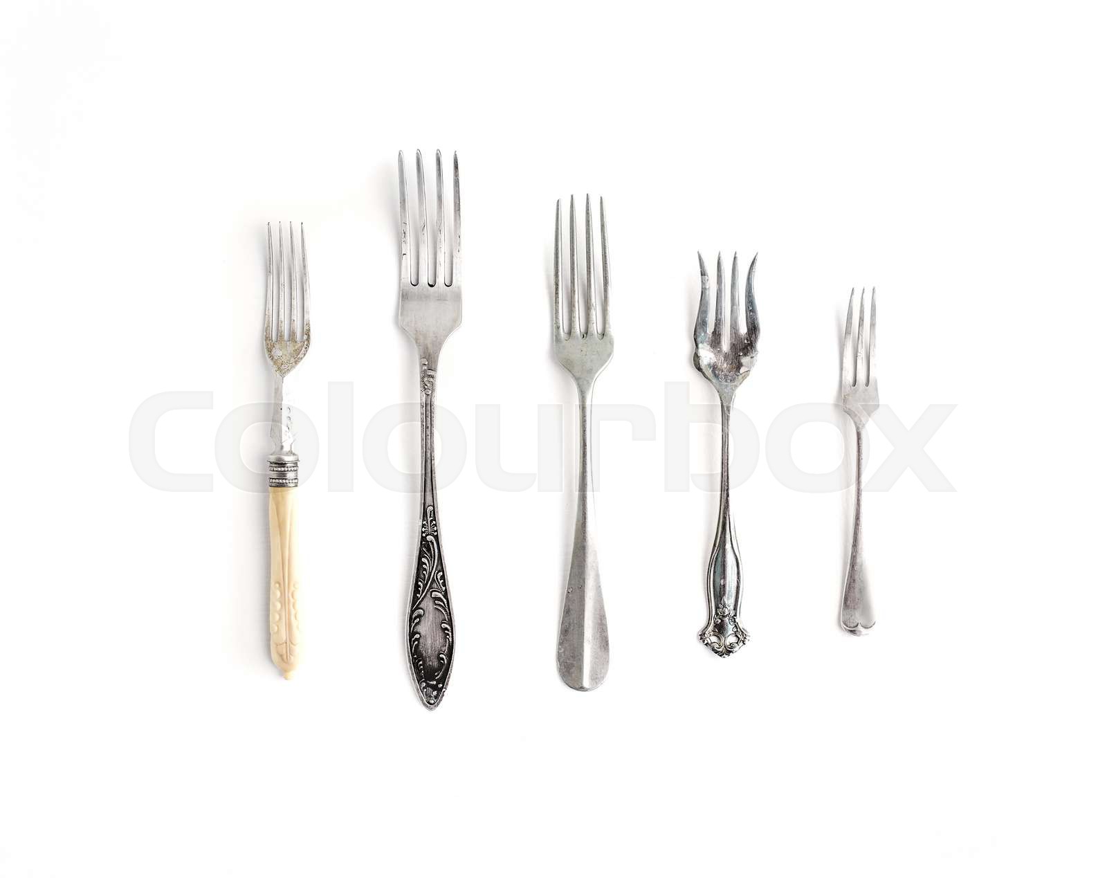 A set of vintage dinnerware: forks of different shapes and sizes ...
