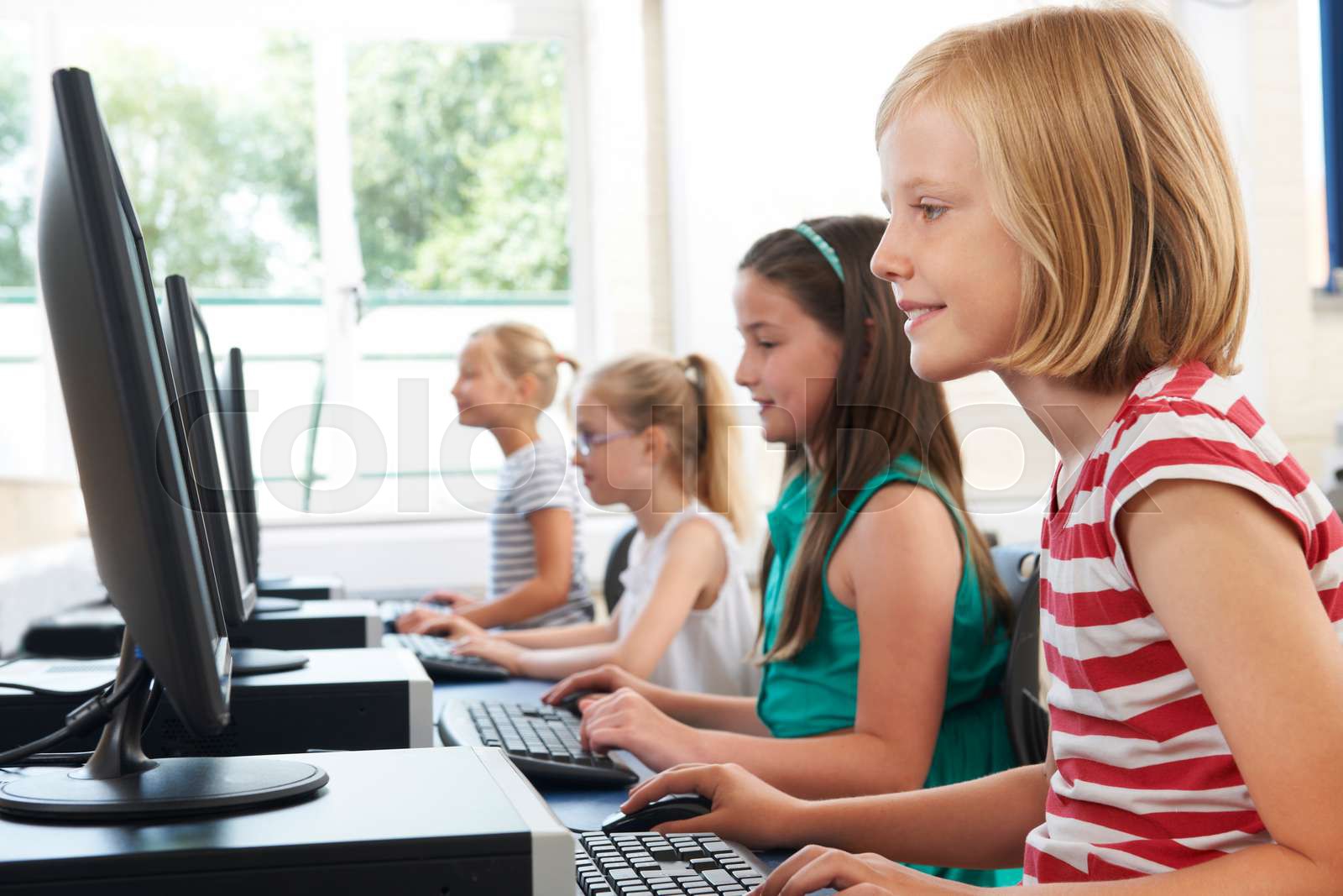 Group Of Female Elementary School Children In Computer Class | Stock ...
