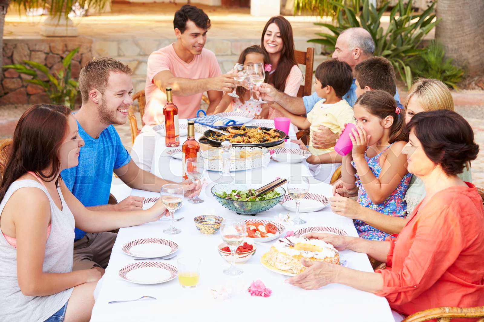 Large Family Group Enjoying Meal On Terrace Together | Stock image ...