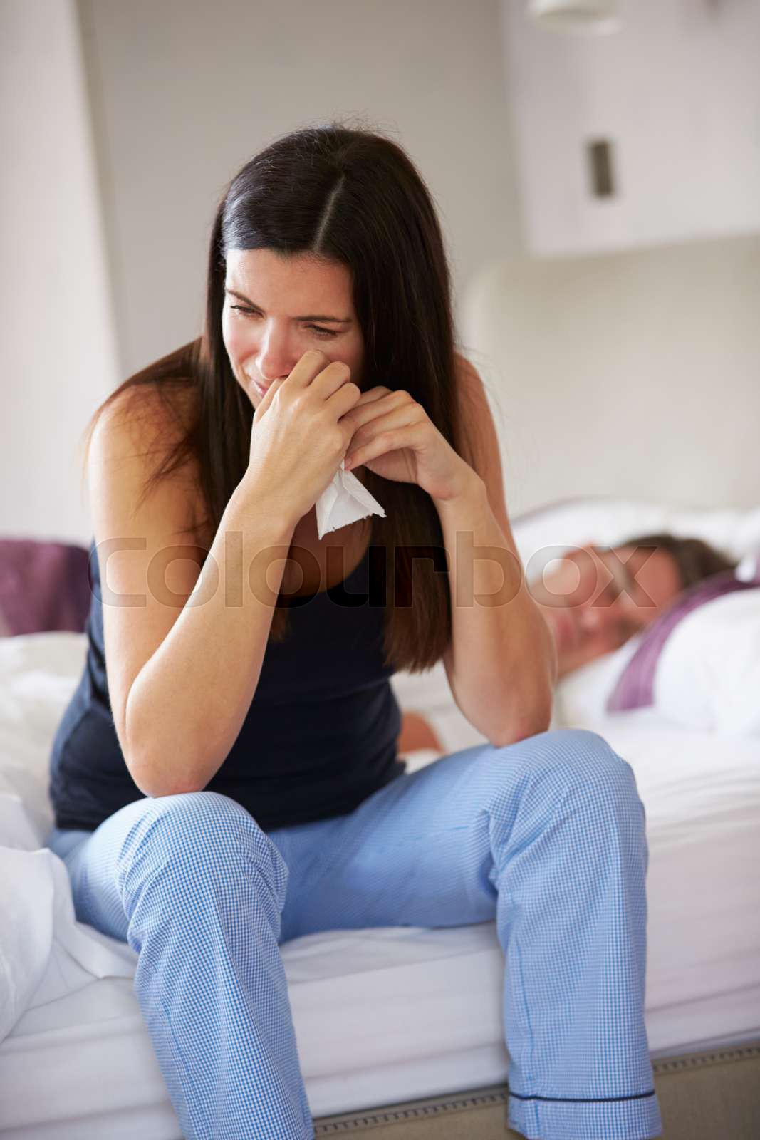 Woman Suffering From Depression Sitting On Bed And Crying | Stock image ...