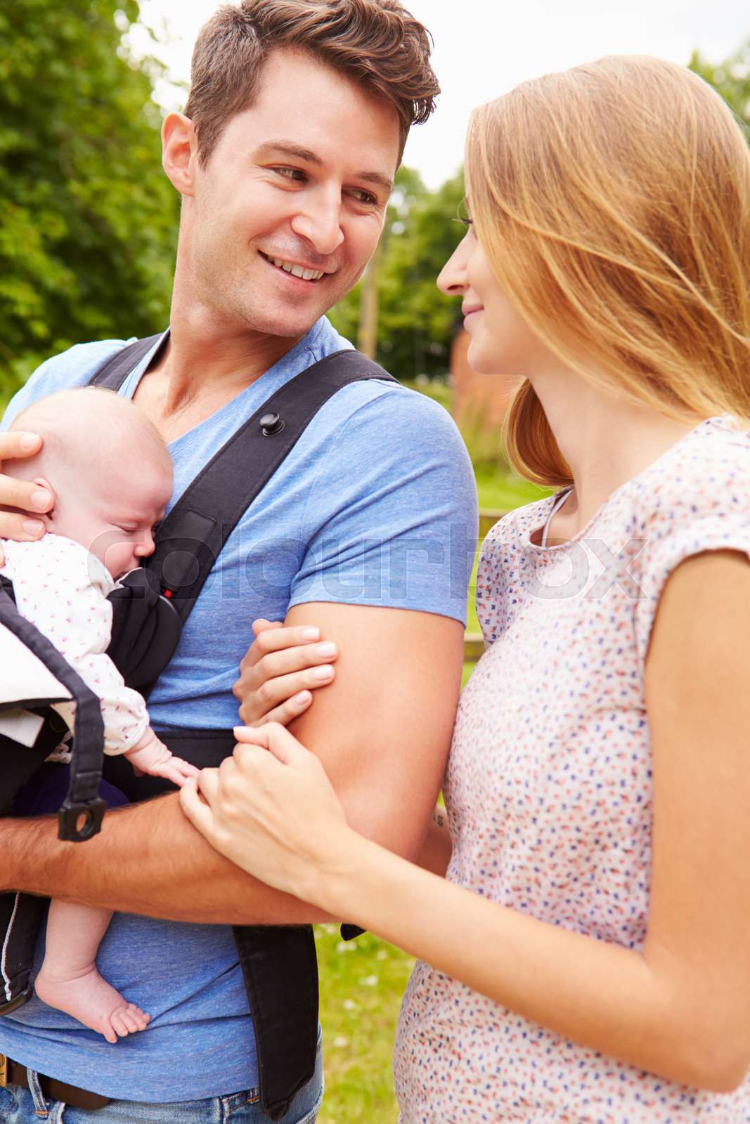 Parents With Baby In Carrier On Walk In Countryside | Stock image ...