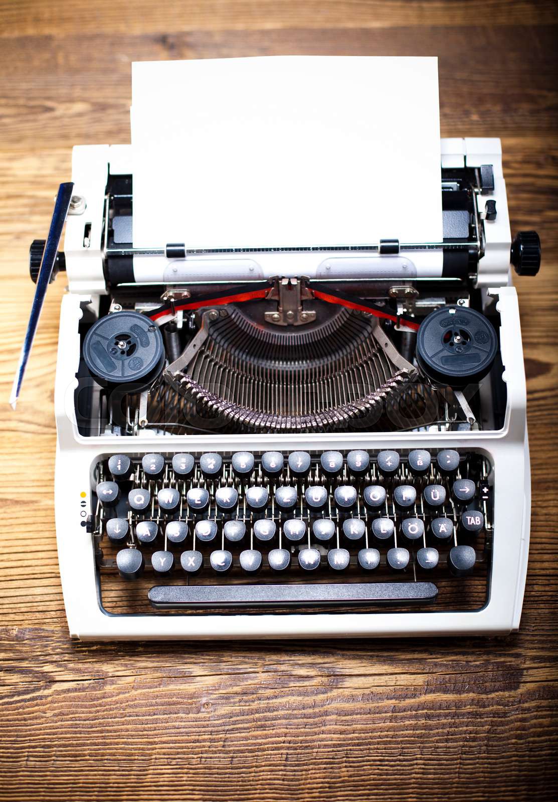 Typewriter and a blank sheet of paper | Stock image | Colourbox