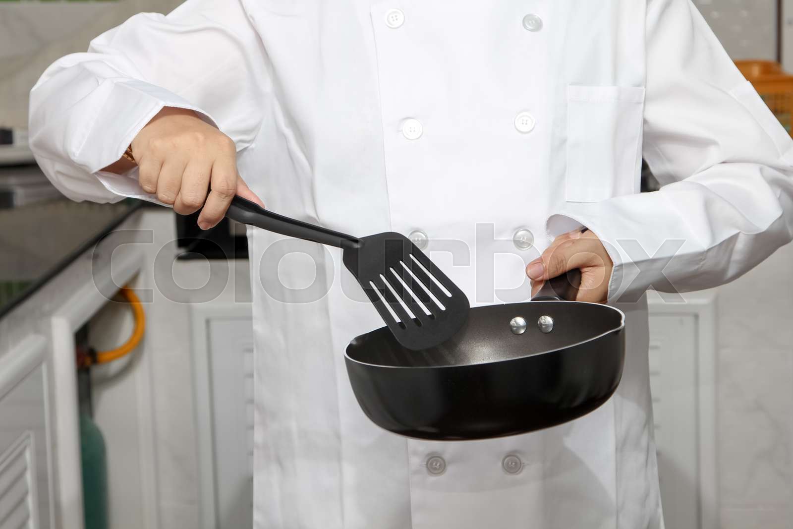 chef holding pan | Stock image | Colourbox